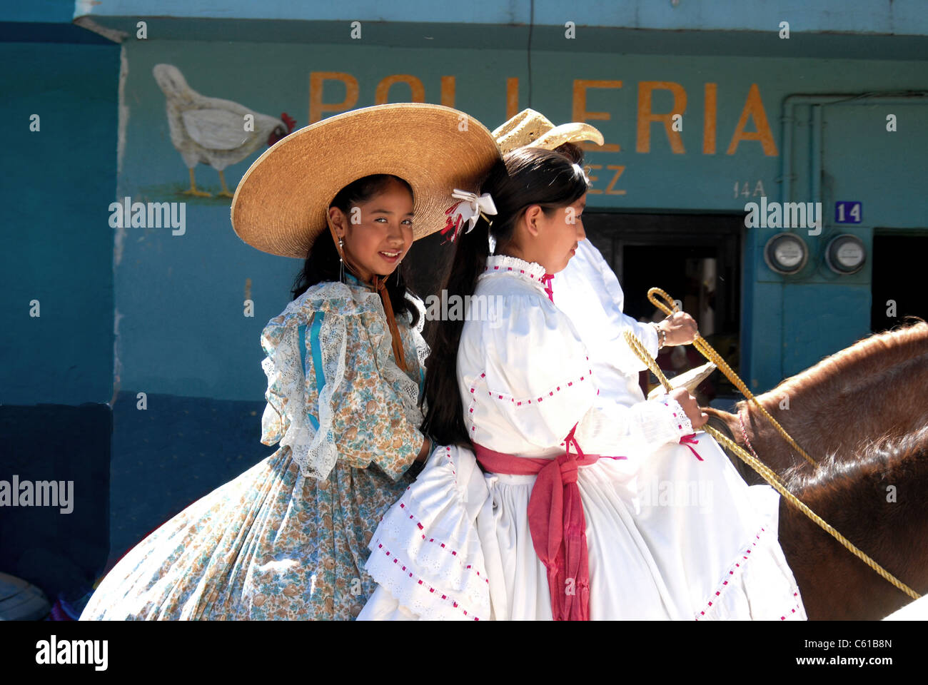 Mexican girls ride on horseback through the small town of Ajijic ...