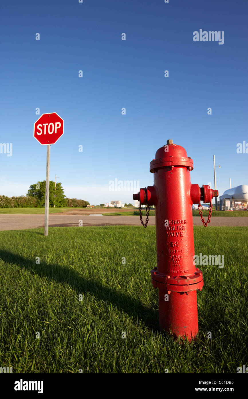 stop sign against blue sky and red darling valve fire hydrant in rural ...