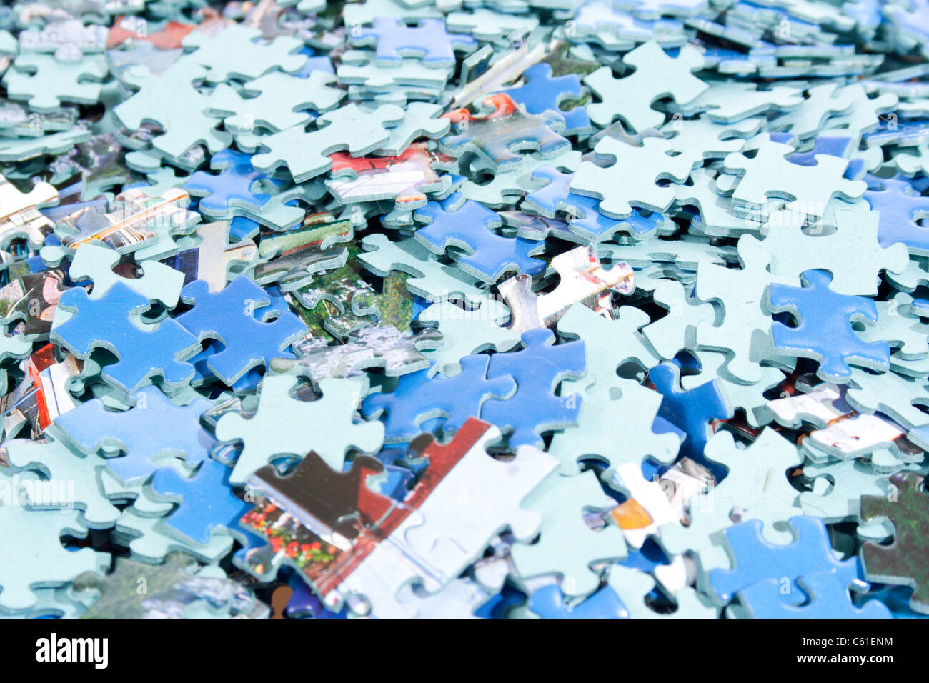 Pieces of puzzle spilled on table, abstract background Stock Photo - Alamy