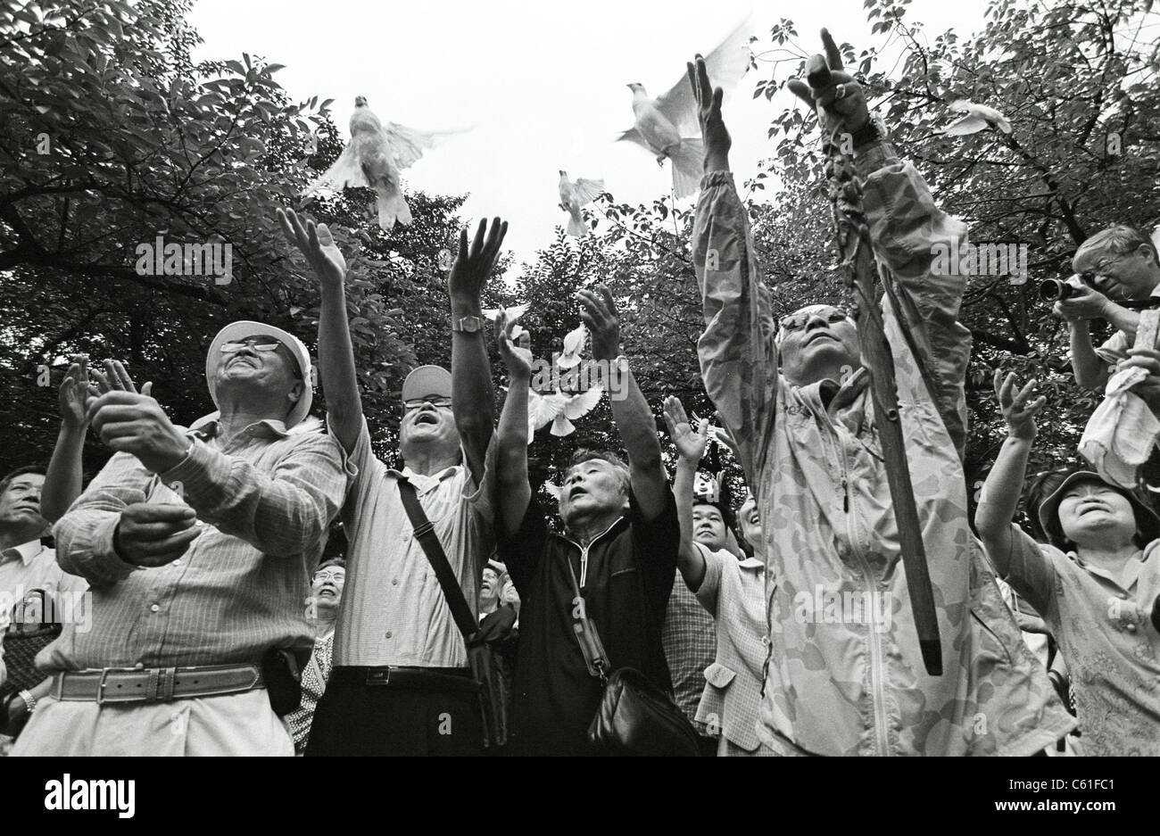 People release white doves in hopes of peace at commerations for the ...