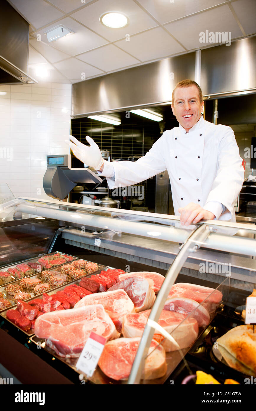 Portrait of a happy butcher welcoming customers to the shop Stock Photo ...