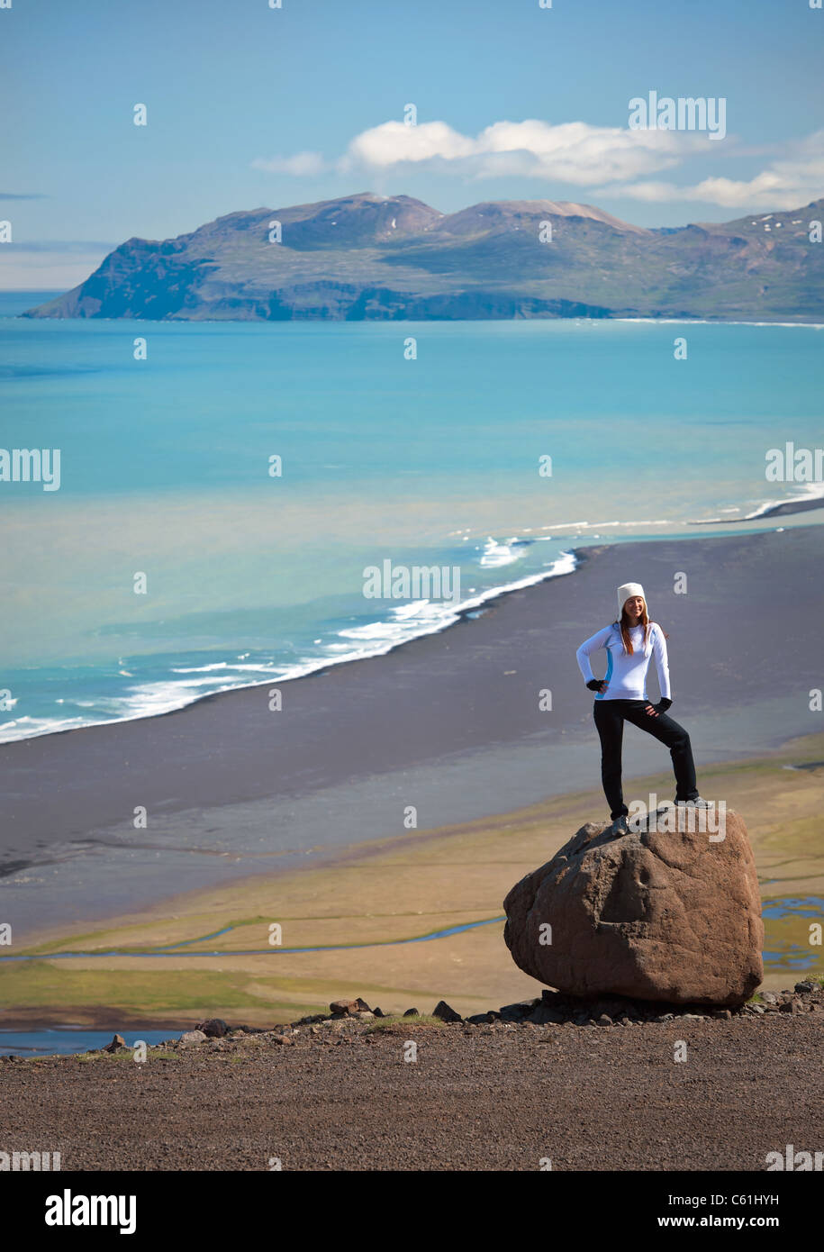 young woman standing on the rock, beautiful Icelandic landscape in the ...