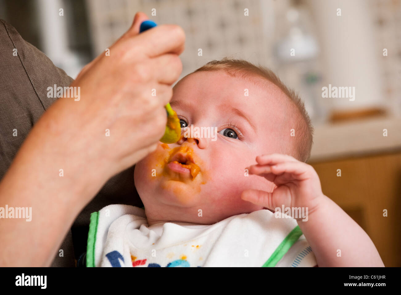 Five months old baby boy being spoon fed Stock Photo - Alamy