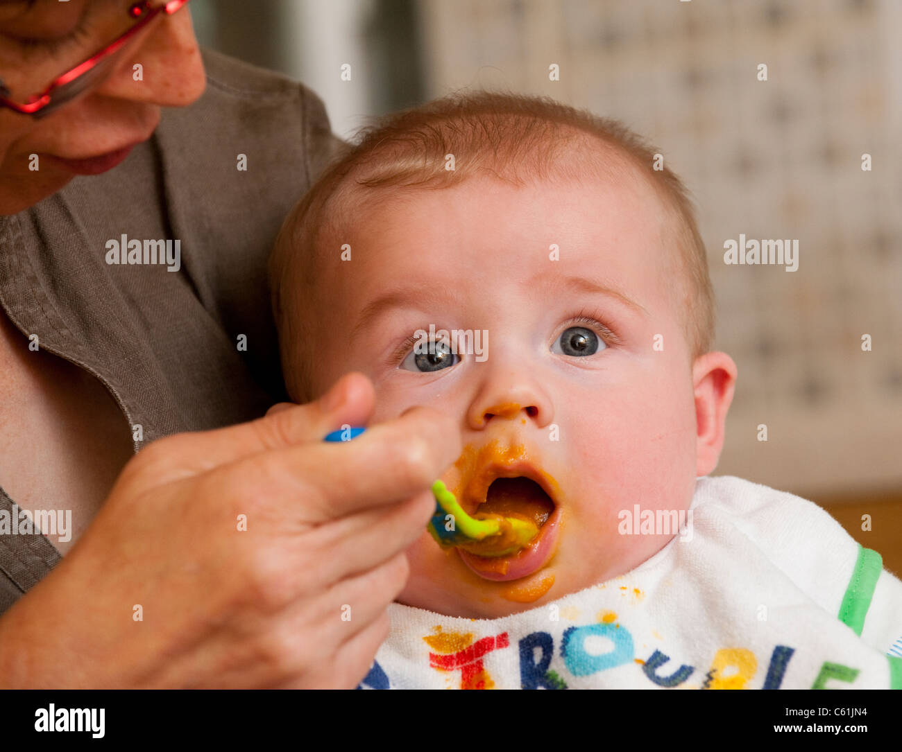 Five months old baby boy being spoon fed Stock Photo - Alamy
