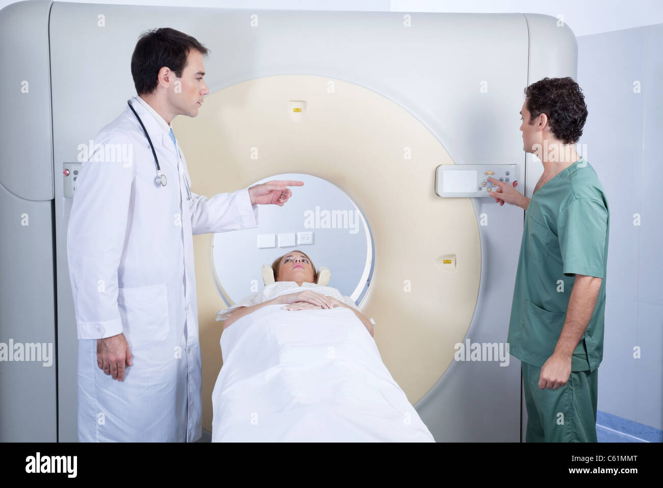 Doctor giving instructions to technician for carrying out MRI scan ...