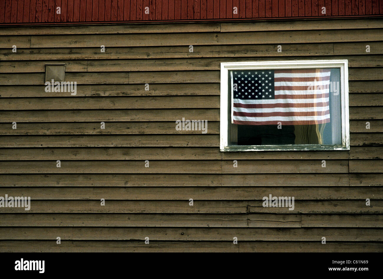 The stars and stripes displayed in the window of a house in Juneau ...