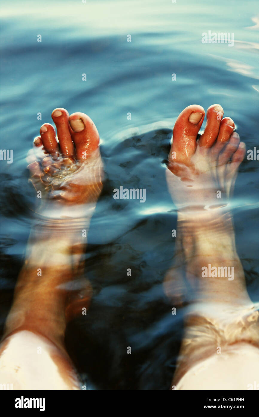 Feet in water Stock Photo - Alamy
