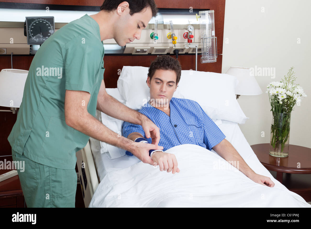 Technician doing a routine check up of the patient Stock Photo - Alamy
