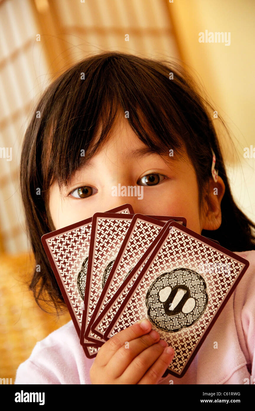 Asian child (girl, 4 years old) hiding behind playing cards Stock Photo ...