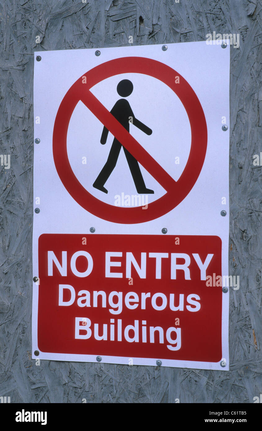 no entry warning sign on boarded up and derelict building in Leeds UK ...