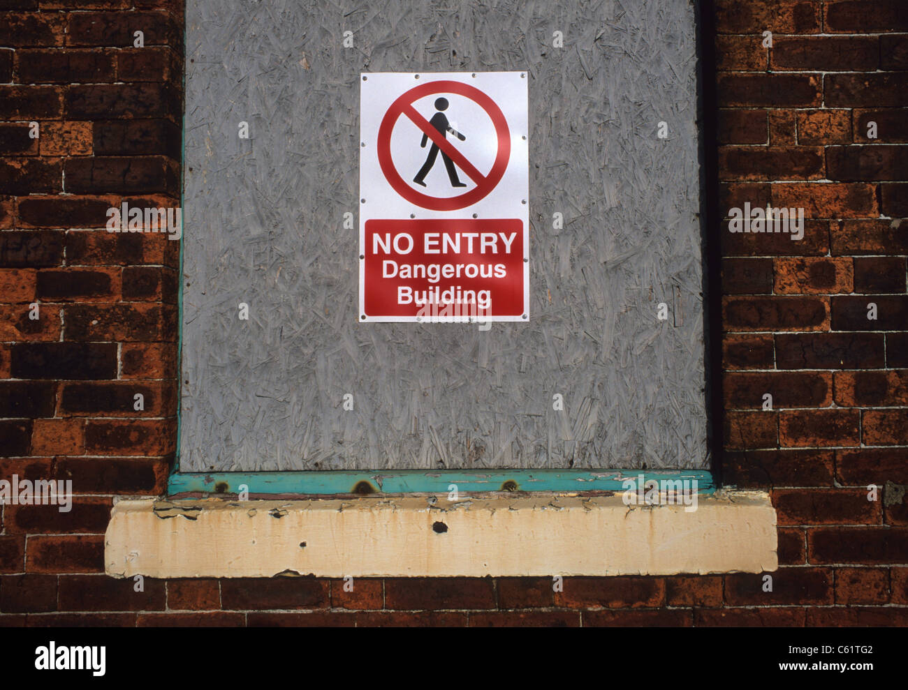 no entry warning sign on boarded up and derelict building in Leeds UK ...