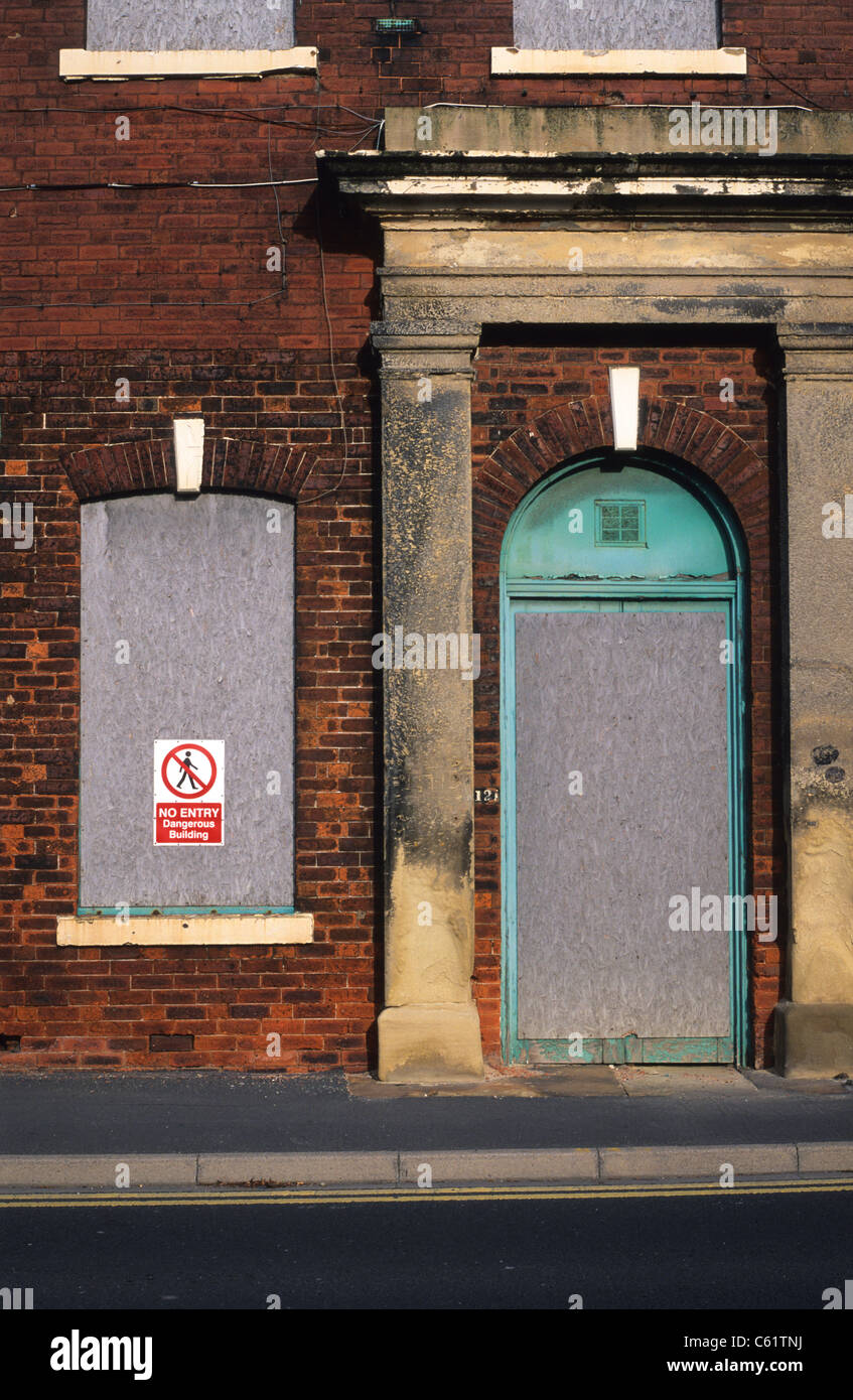 no entry warning sign on boarded up and derelict building in Leeds UK ...