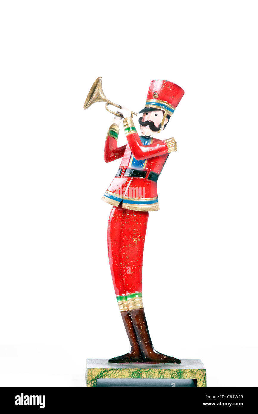 A toy soldier trumpet player isolated against a white background in the ...