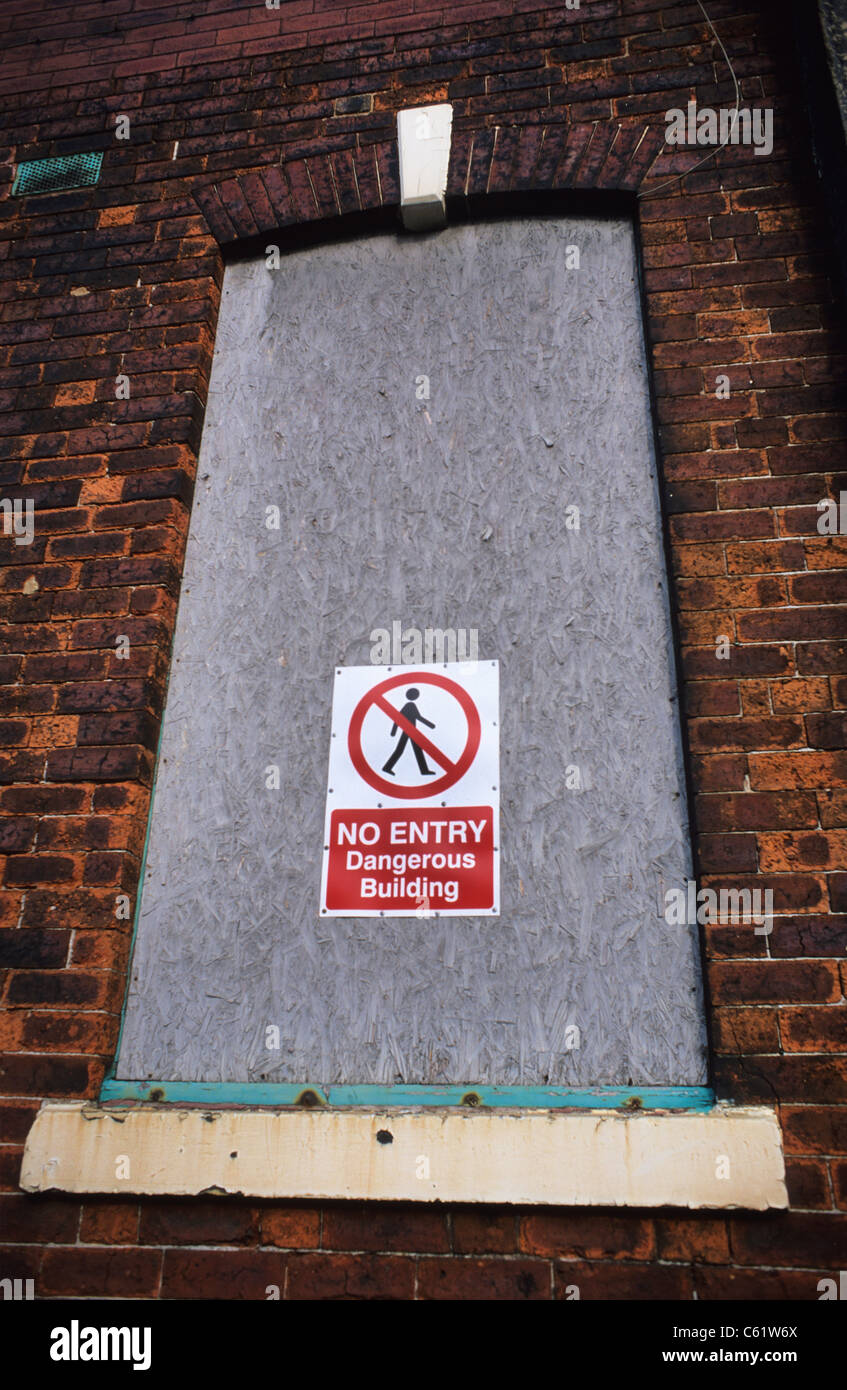 no entry warning sign on boarded up and derelict building in Leeds UK ...