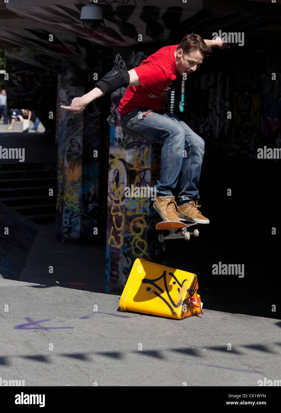 Skateboarder jumping over an obstacle Stock Photo - Alamy