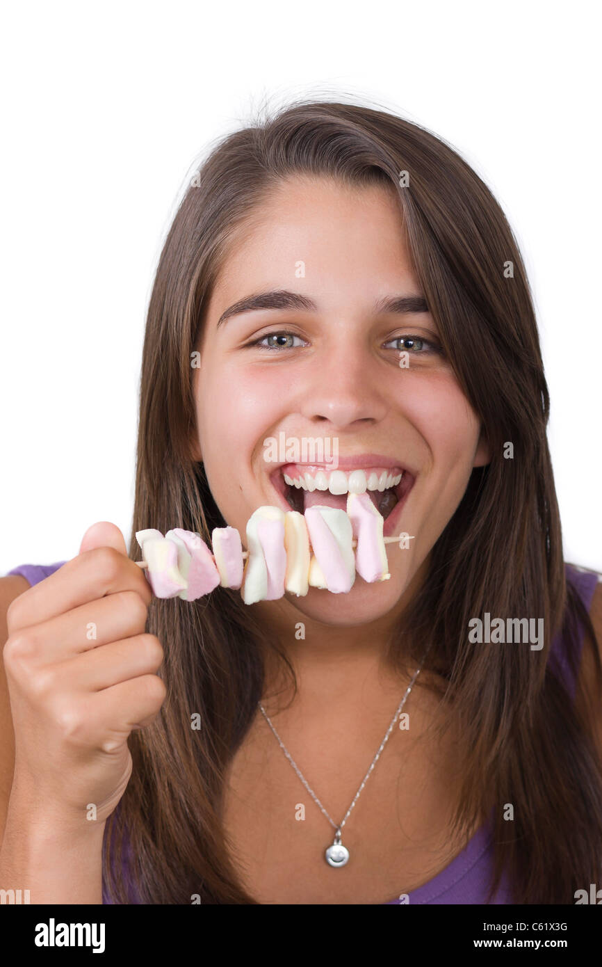 Pretty young woman eating marshmallows on a stick Stock Photo - Alamy