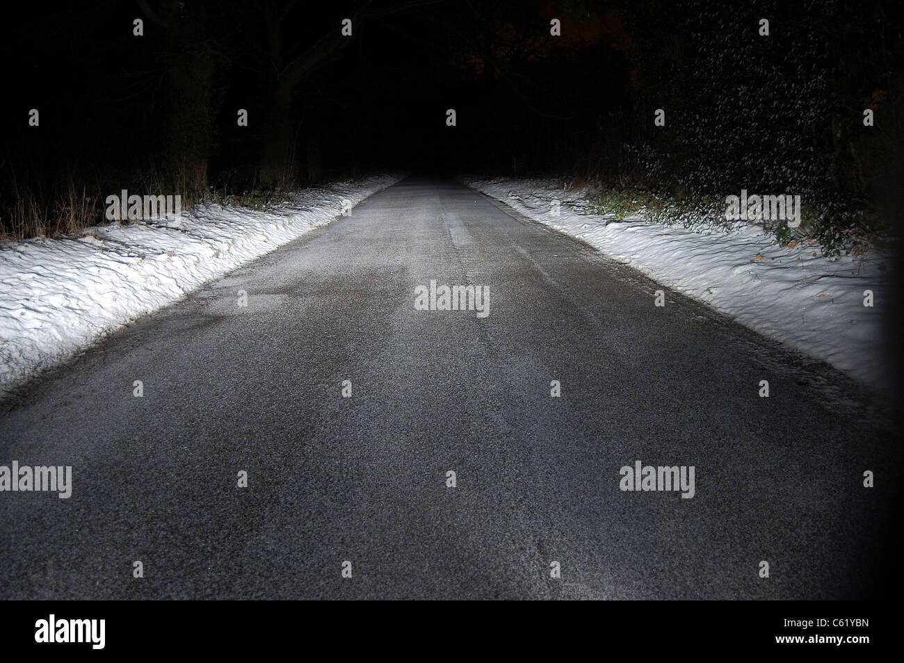 Snowy car lit road Stock Photo - Alamy