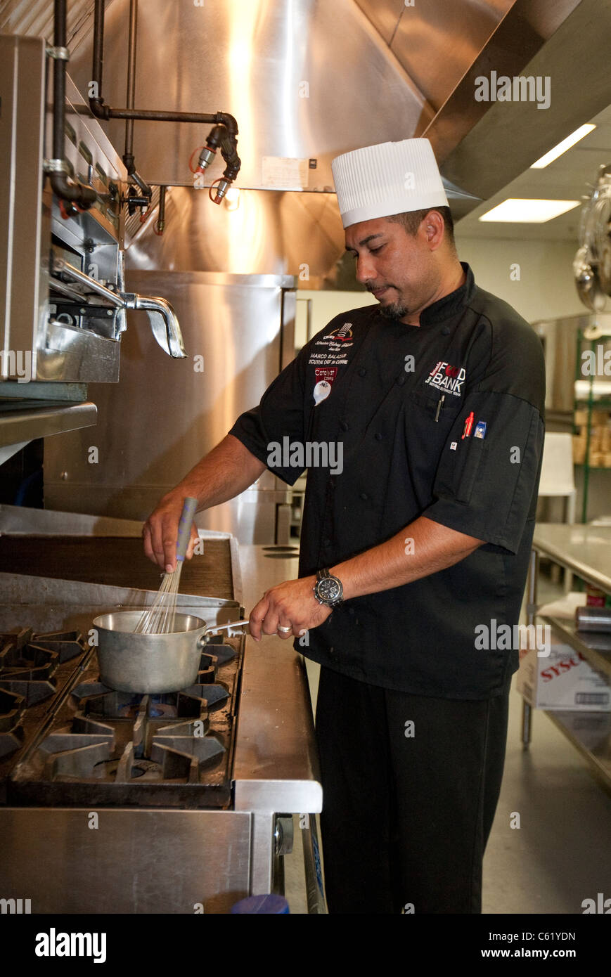 Chefs work in the kitchen of the San Antonio Food Bank in San Antonio ...