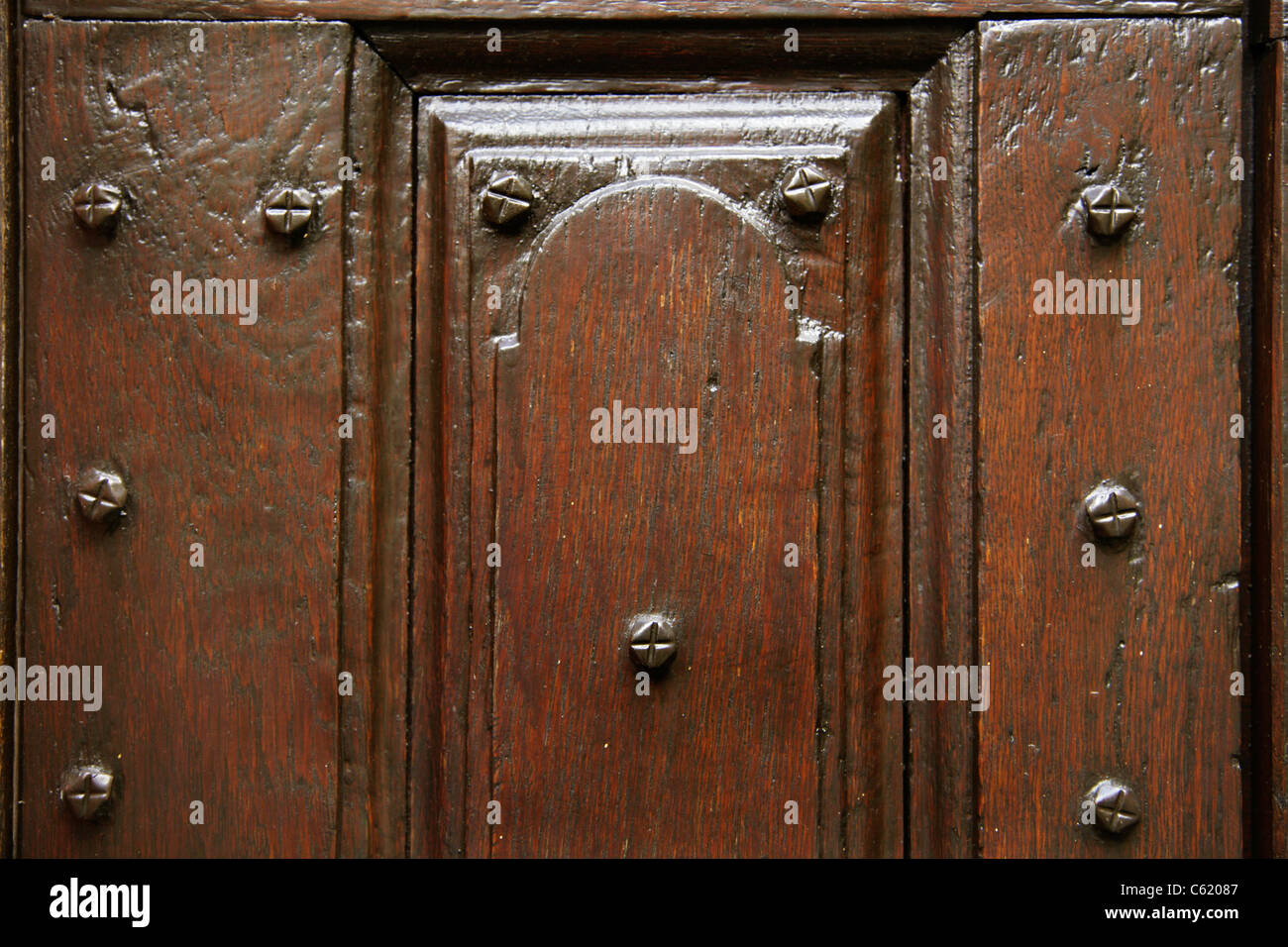 Detail of old handmade screws in timber panelled door Stock Photo - Alamy