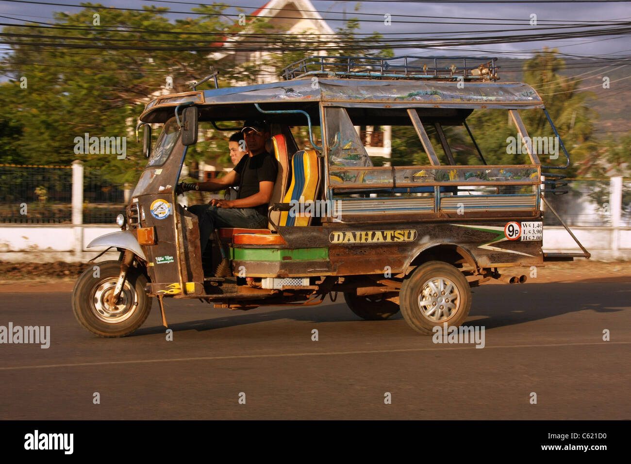 Decorated rickshaw taxi speeding through Pakse Laos Stock Photo - Alamy
