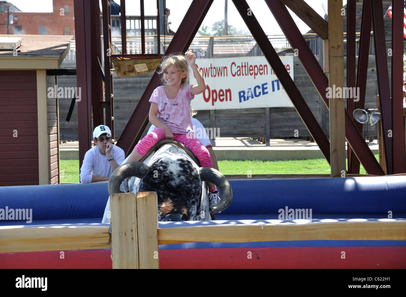 Girl riding mechanical bull hi-res stock photography and images - Alamy