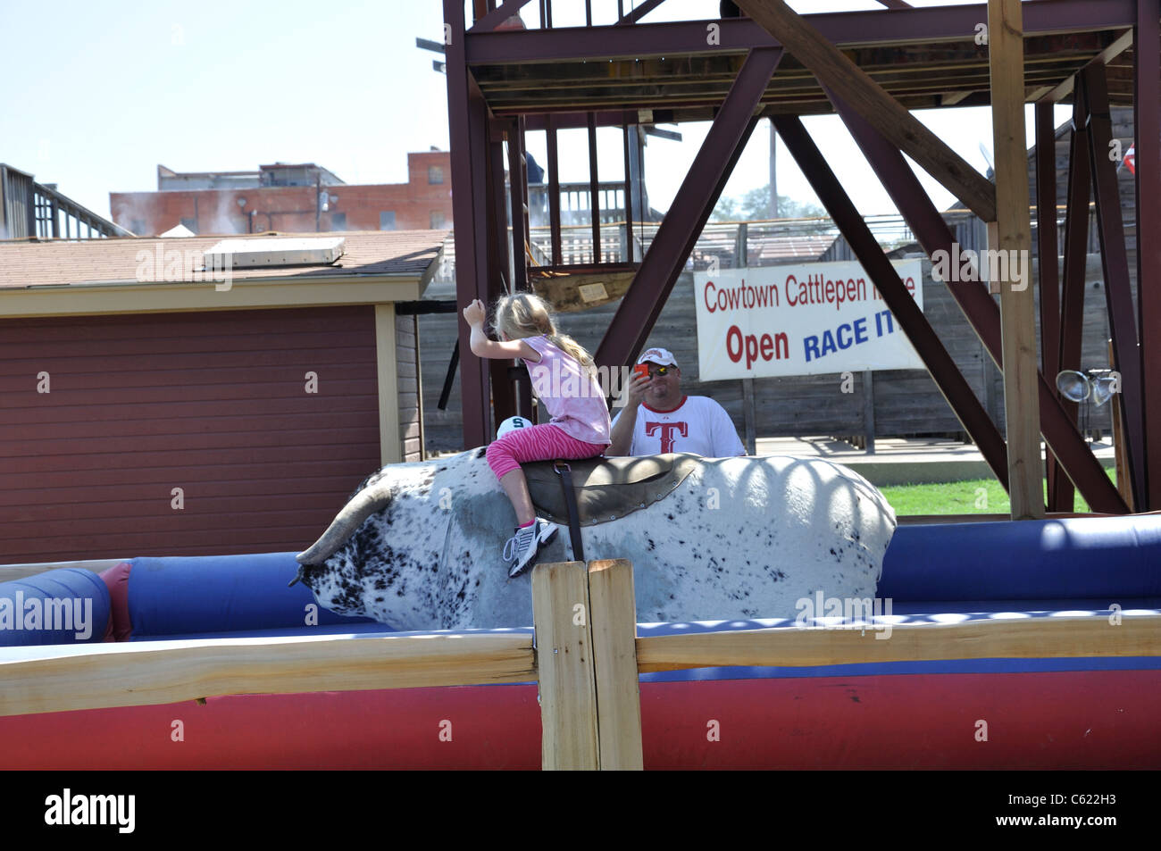 Girl riding mechanical bull hi-res stock photography and images - Alamy