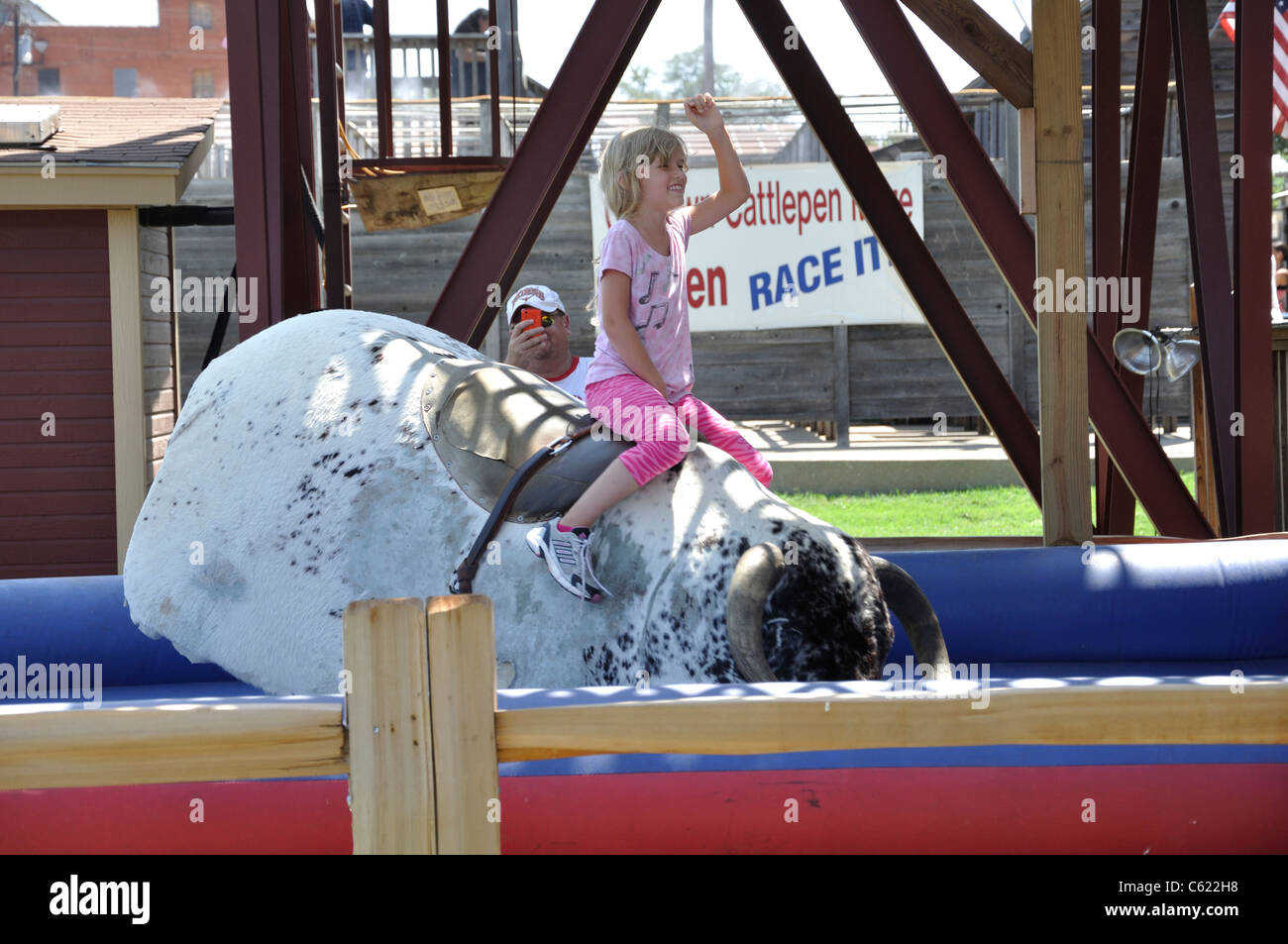 Little girl on mechanical bull ride, Stockyards, Fort Worth, Texas, USA ...