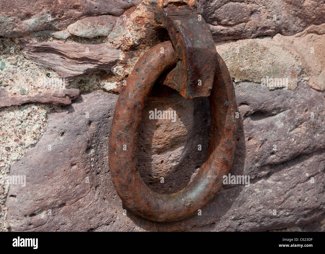 Rusty Iron Ring on old pilchard store once used to tie up fishing boats ...