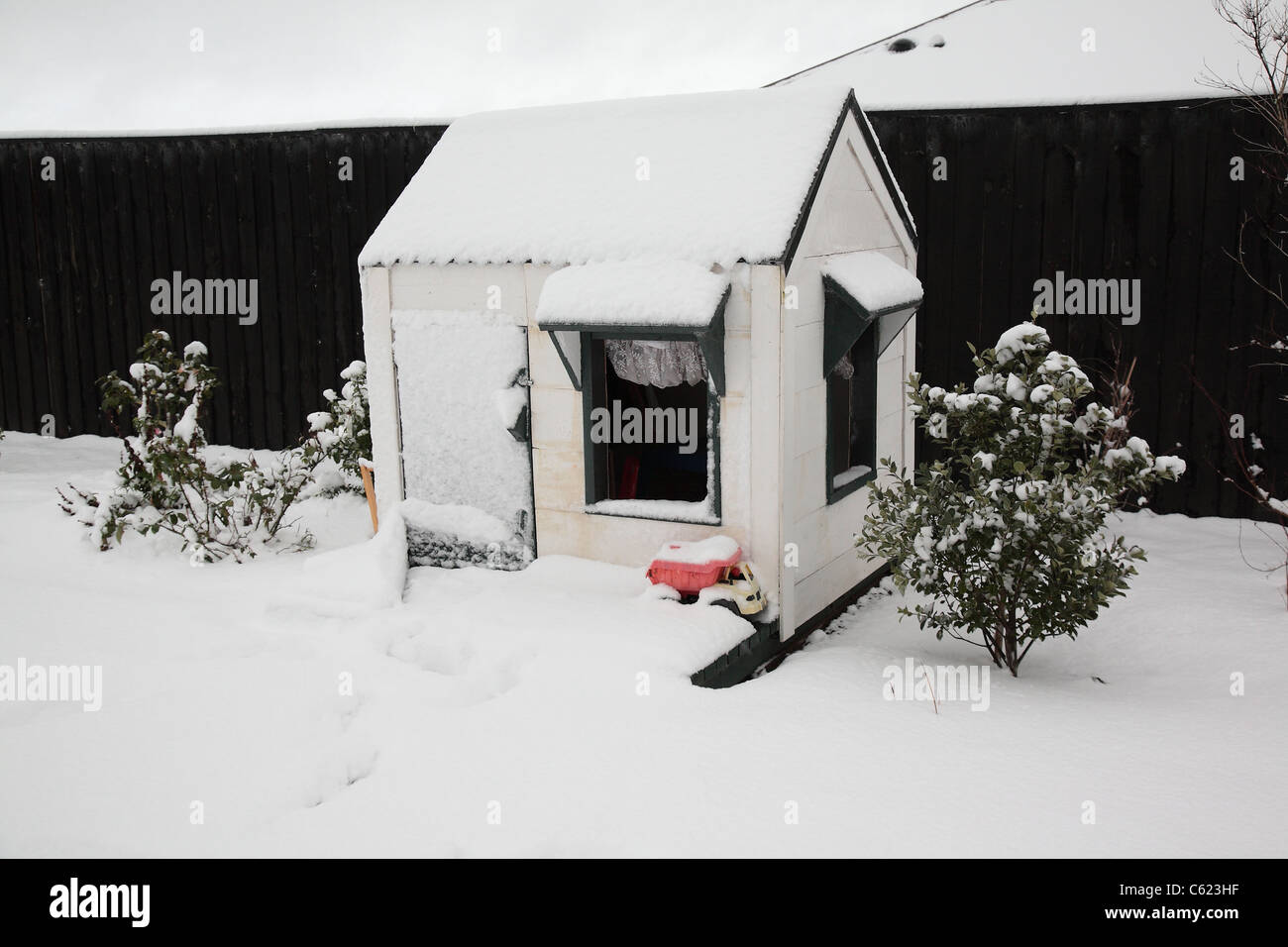 Snow covering a child's playhouse in winter Stock Photo - Alamy