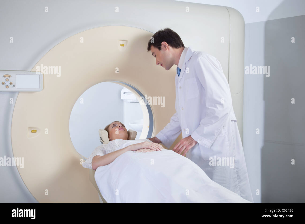 Doctor examining patient before CT scan Stock Photo - Alamy