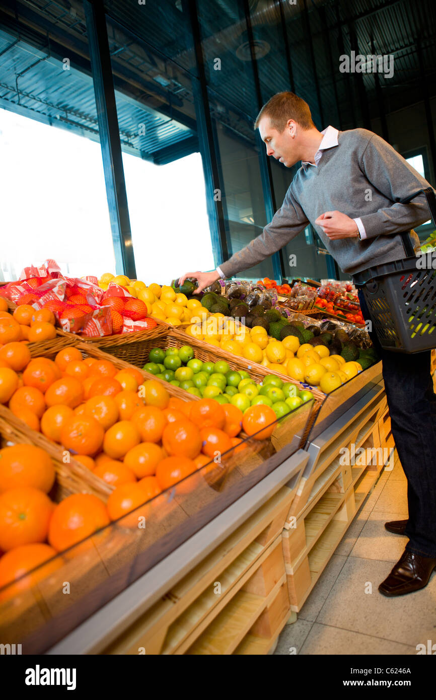 A man in a grocery store buying fruits and vegetables Stock Photo - Alamy