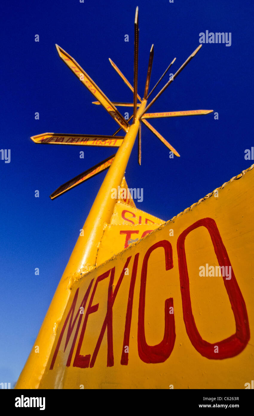 Yellow signpost with directions and mileage to the Worlds major cities ...