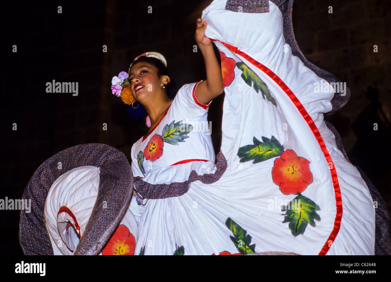 Smiling flamingo danser swinging her gown at night in Mexico Stock ...