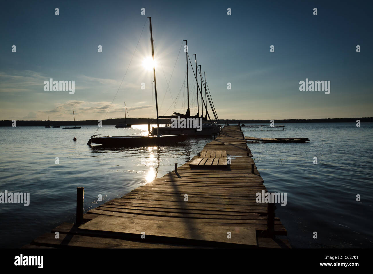 Sunset in wooden harbour at summer Stock Photo - Alamy