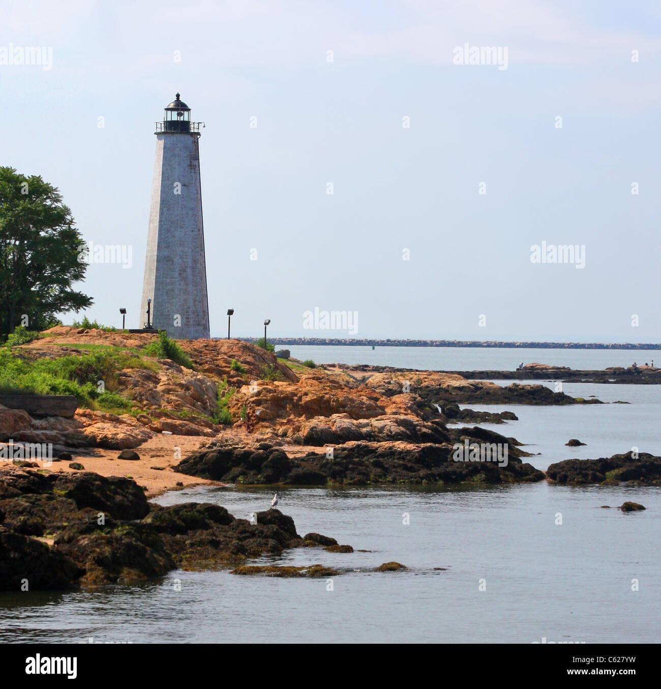 Five Mile Point lighthouse on the coast with rocks Stock Photo - Alamy