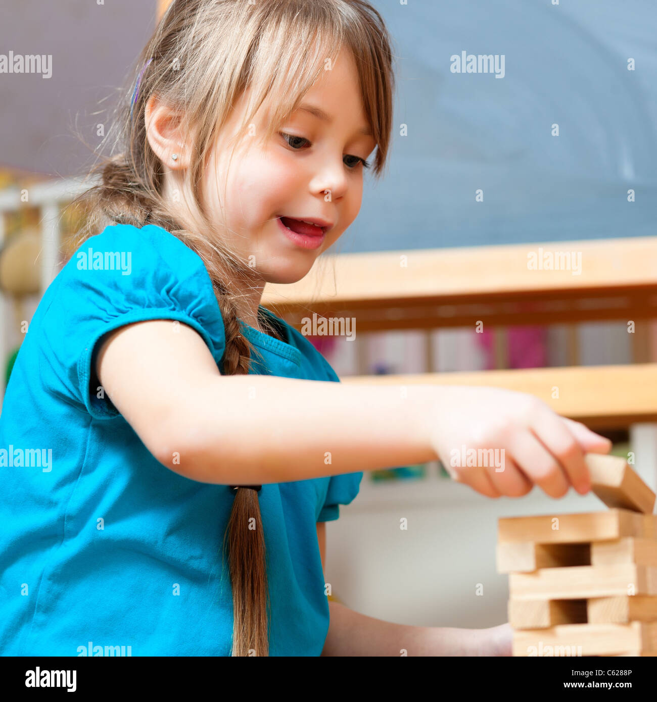 child playing at home with bricks in the nursery Stock Photo - Alamy