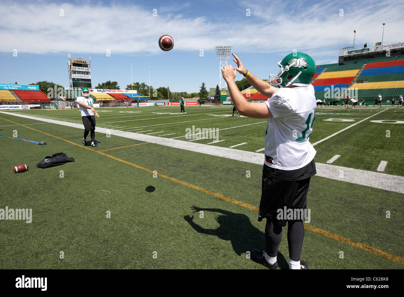 players practice throwing and catching on the sideline during ...