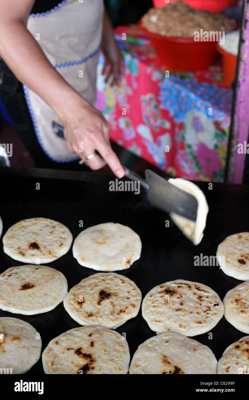 Pupusas cooking on the grill, a national food of El Salvador Stock ...