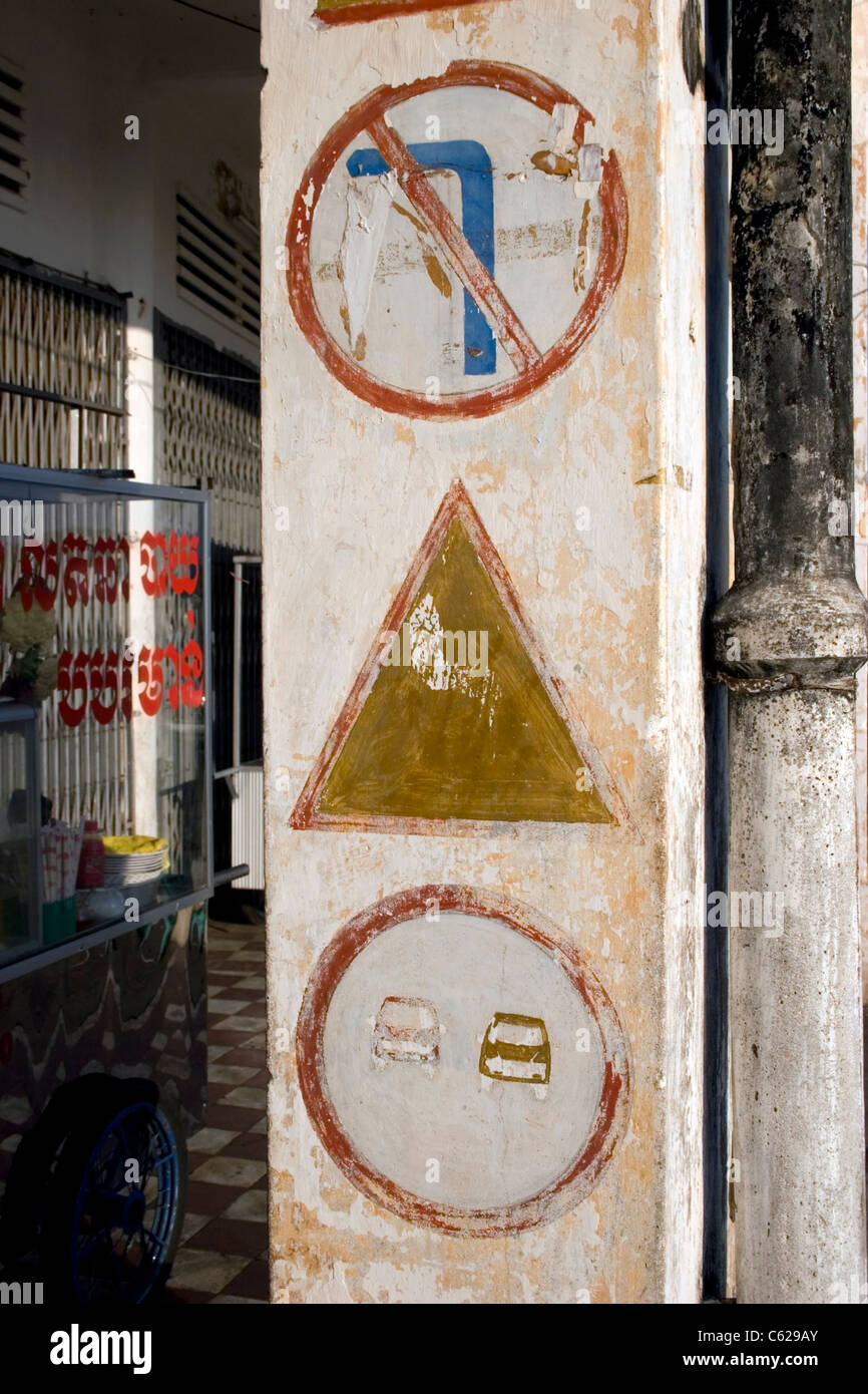 Traffic symbols are painted on an old rundown building in Kampong Cham ...