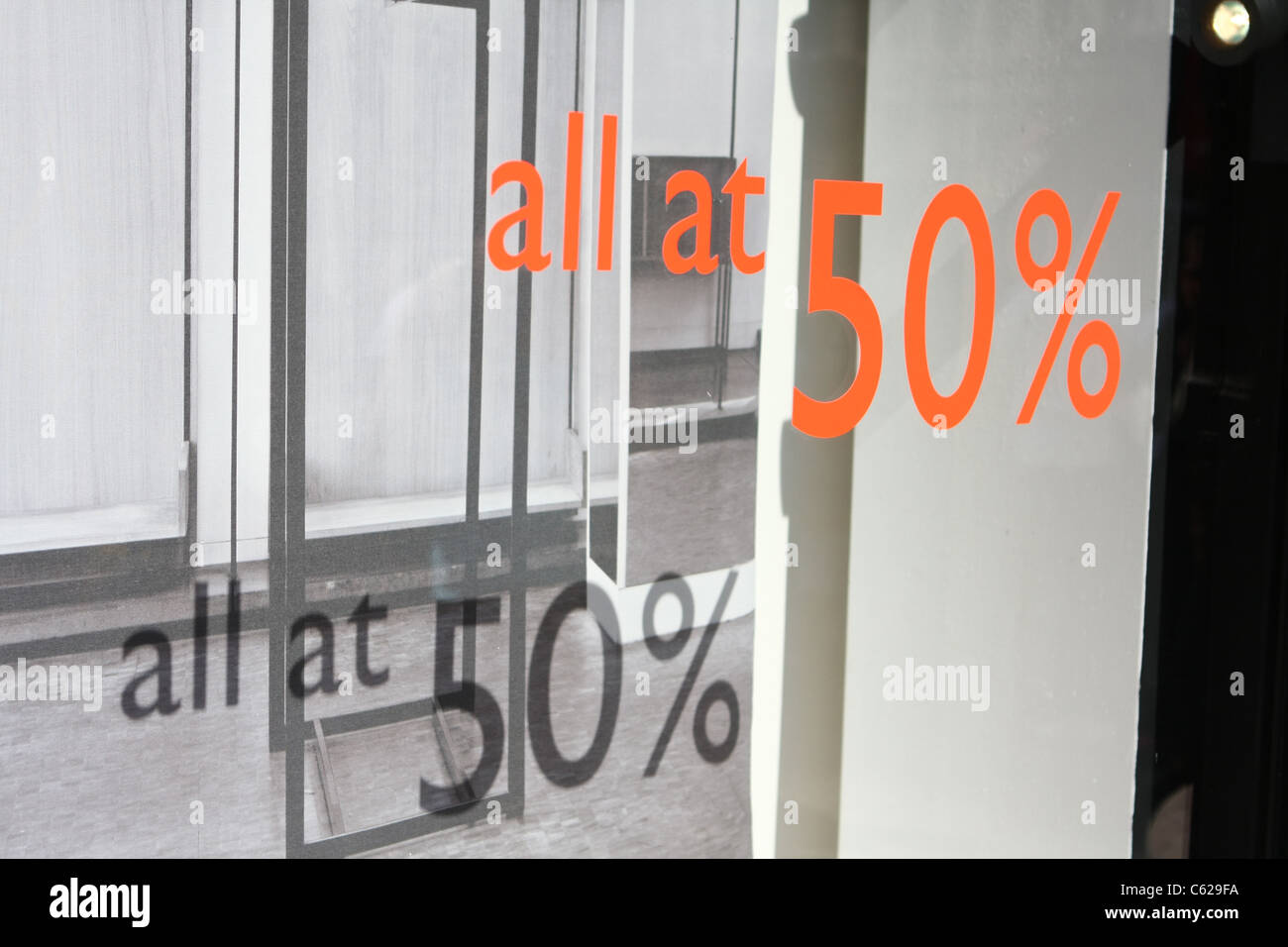 an "all at 50%" sign and its shadow in a shop window Stock Photo - Alamy