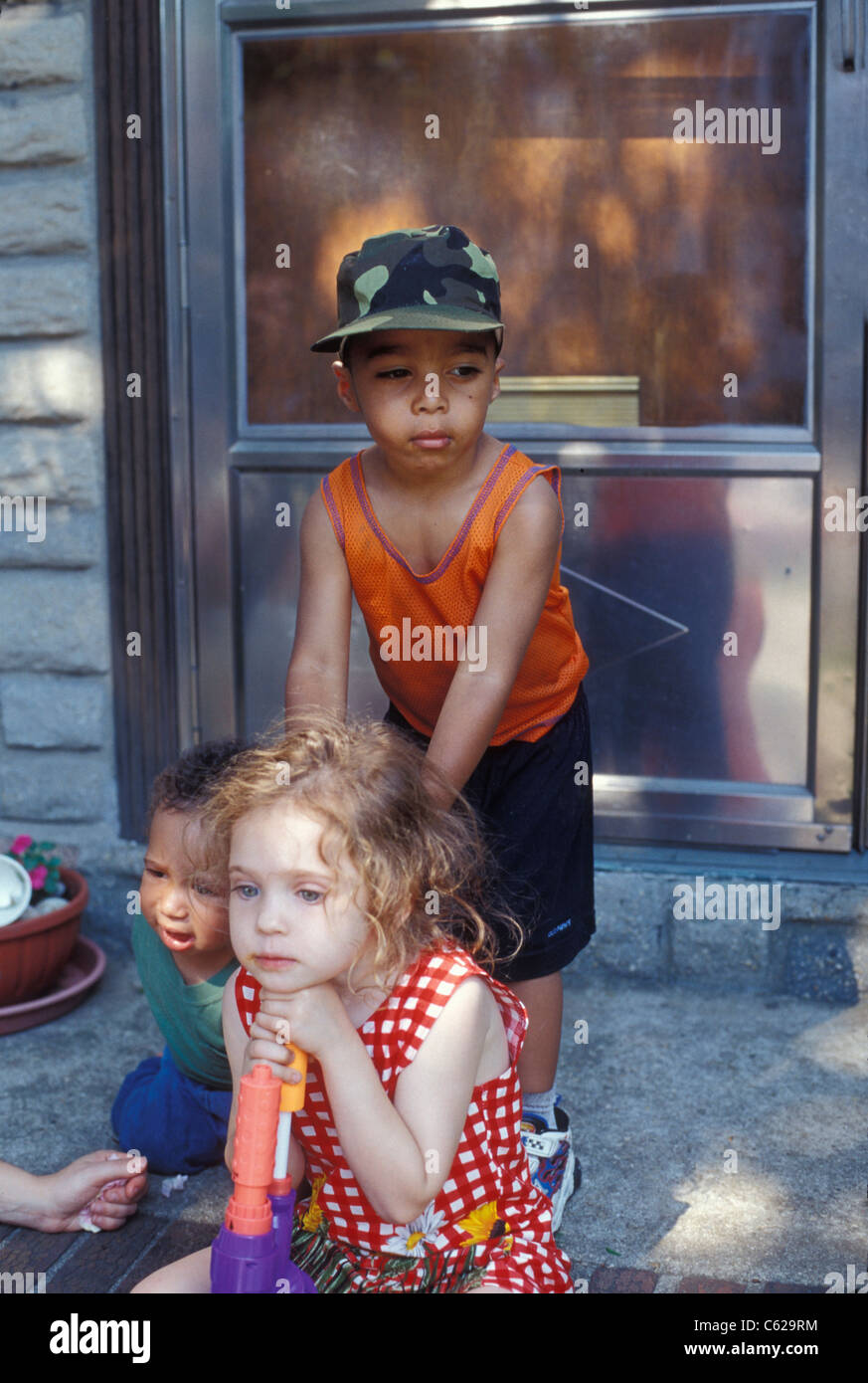 Friends and neighbors sitting on the stoop of a house in Brooklyn, NY ...