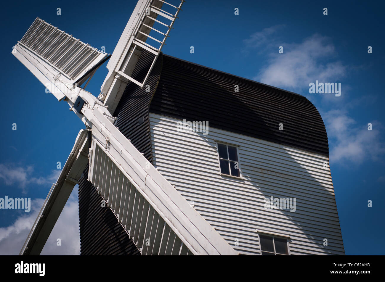 Mountnessing Post Mill set in the english countryside with a blue sky ...