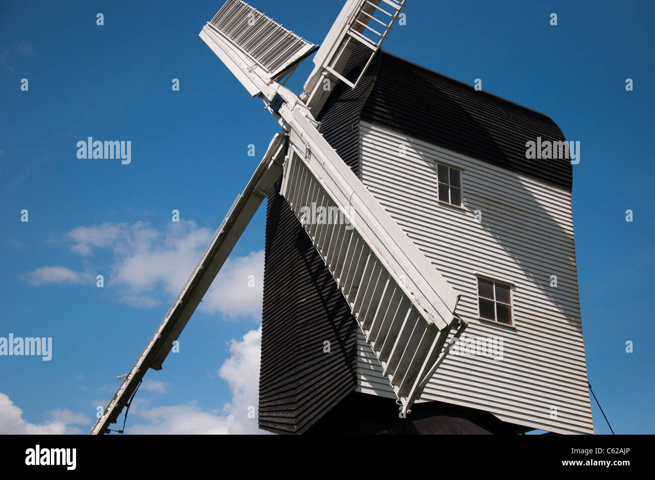 Mountnessing Post Mill set in the english countryside with a blue sky ...