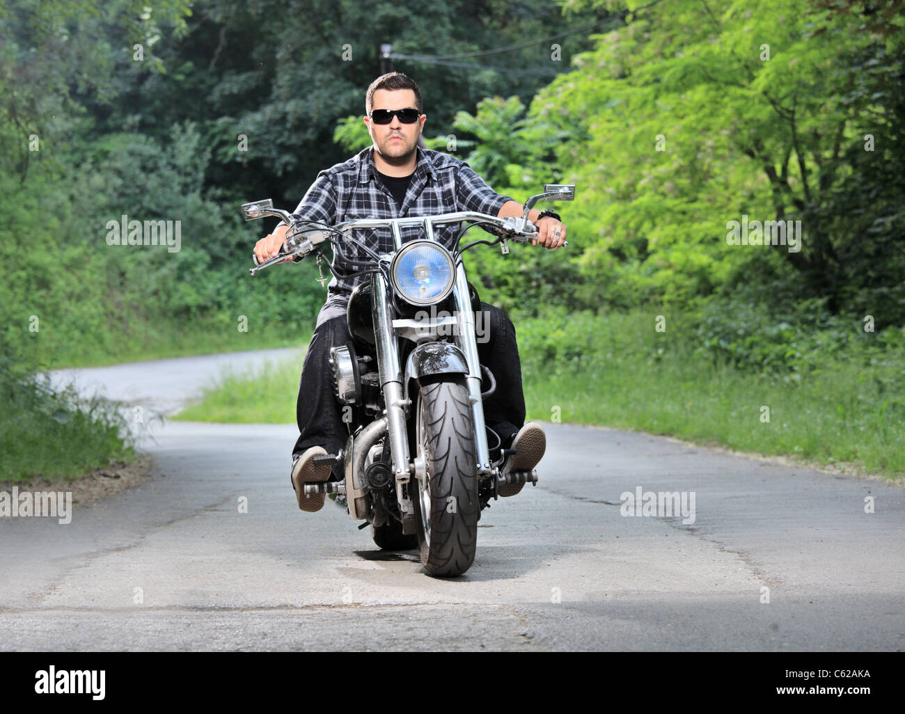 A man riding a chopper on a road Stock Photo - Alamy