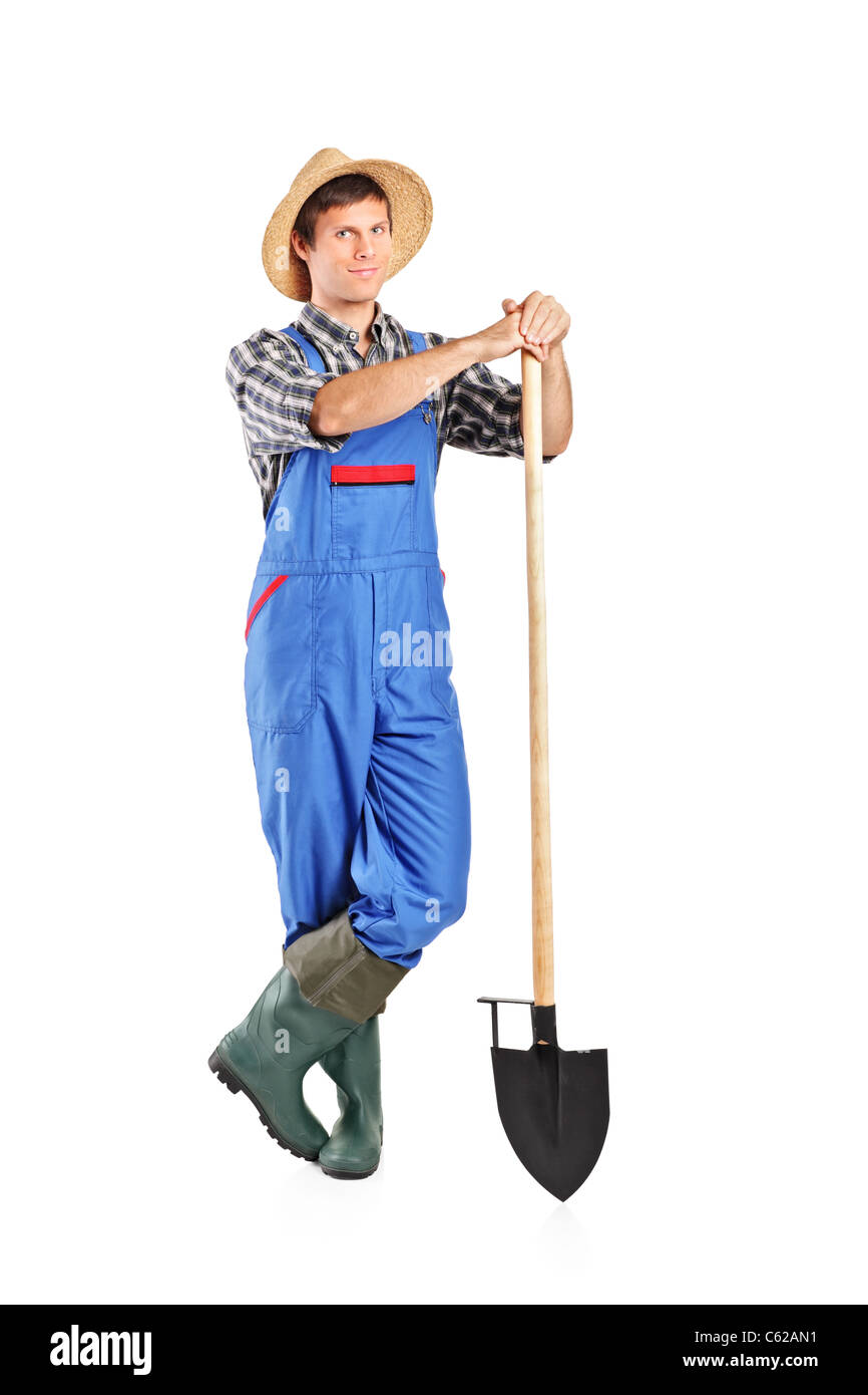 Full length portrait of a male worker holding a shovel Stock Photo - Alamy