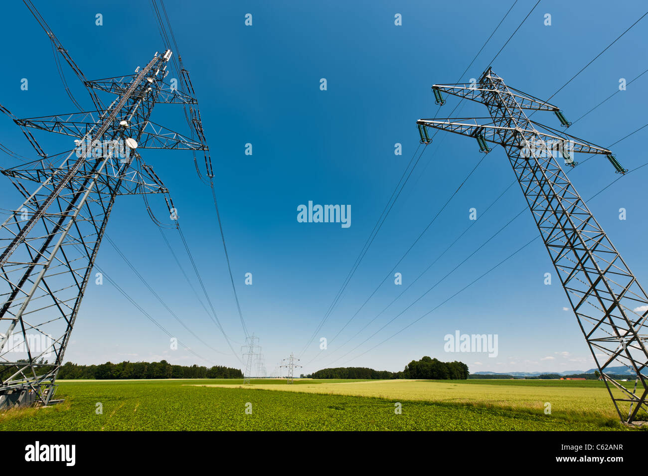 Power lines in a summer landscape with clear sky Stock Photo - Alamy
