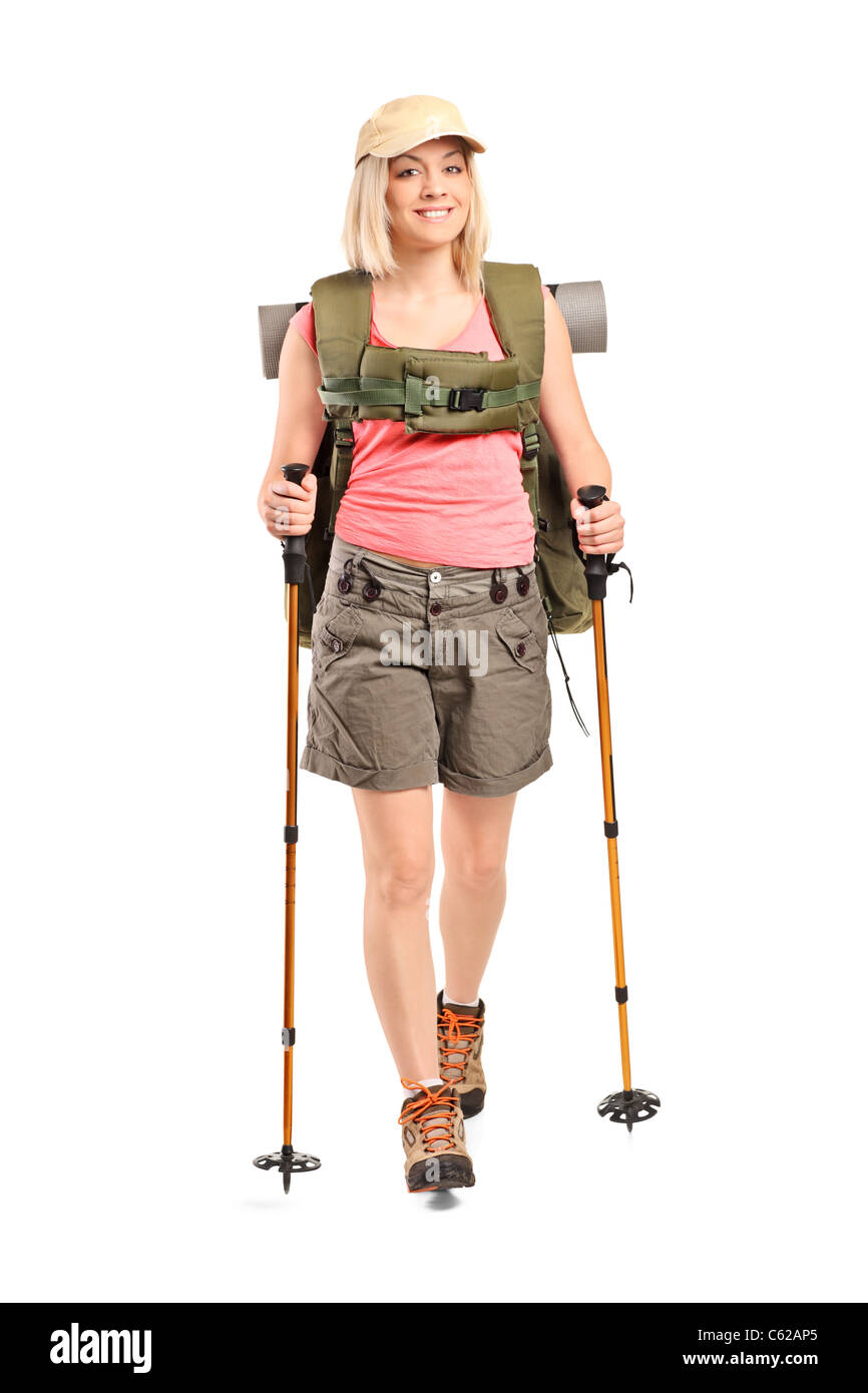 Full length portrait of a smiling woman with backpack and hiking poles ...