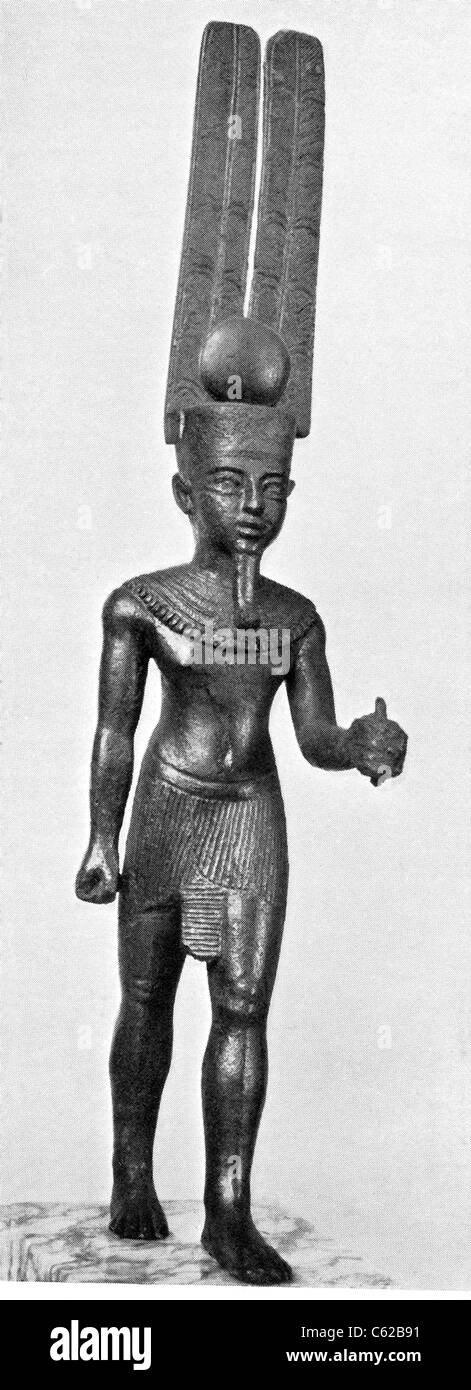 This ancient Egyptian statue depicts the god Amun Re wearing the solar ...
