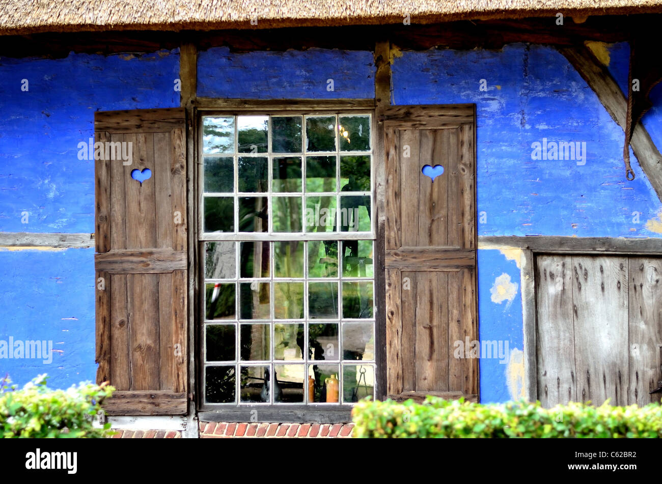Blue heart windows of a blue house Stock Photo - Alamy