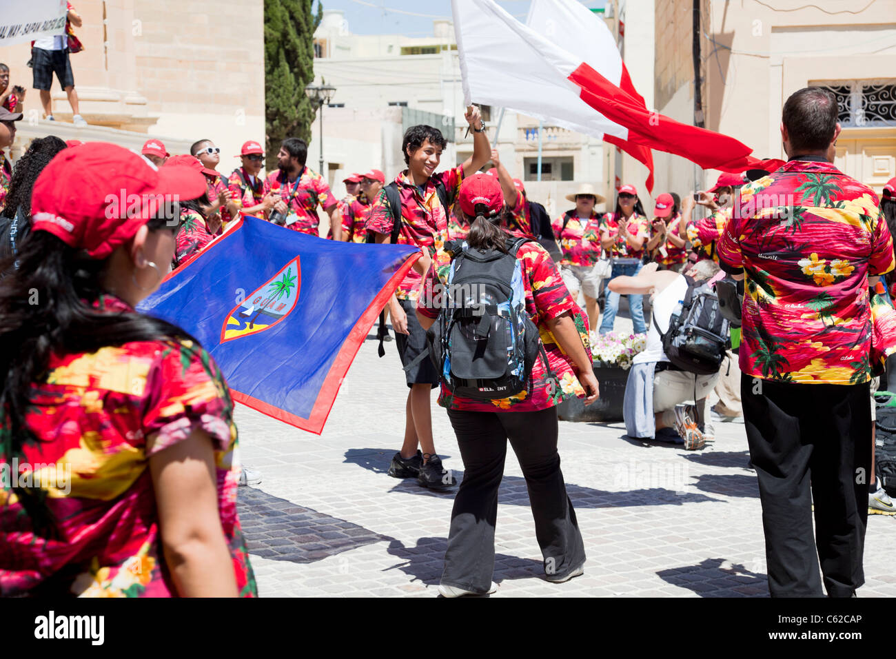 Group of religious people from Guam in colorful red shirt gather ...